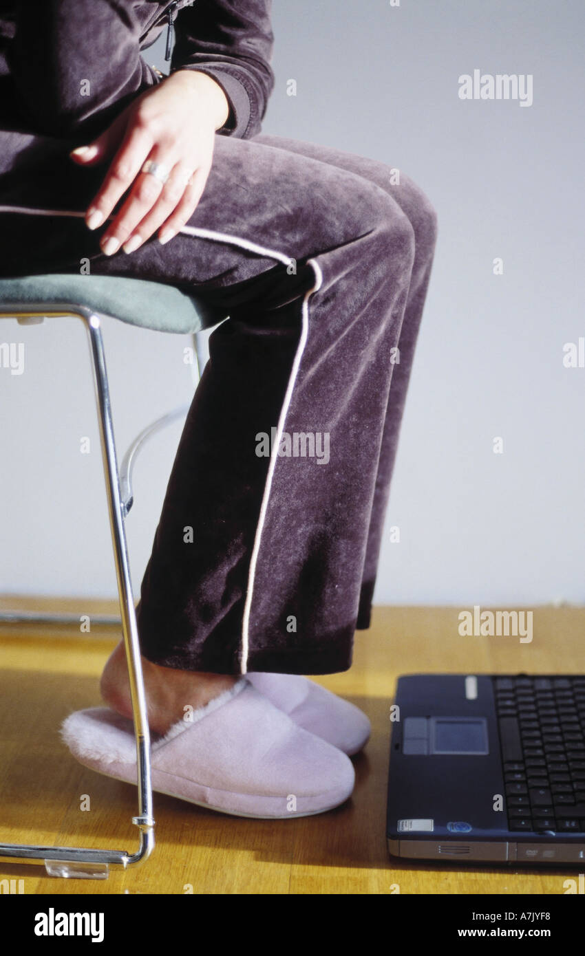 Low section view of a woman sitting on a chair Stock Photo - Alamy