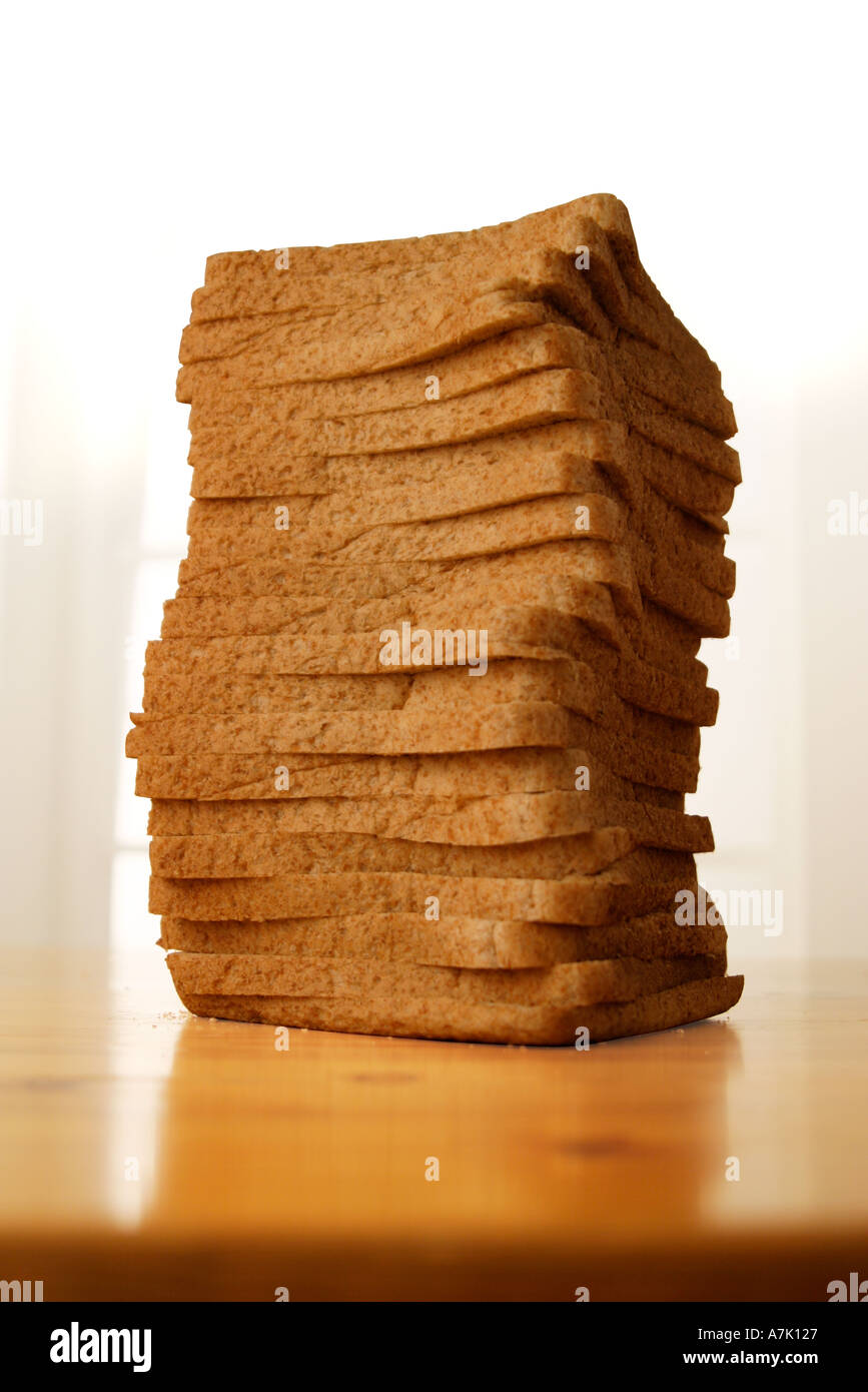 PORTRAIT SHOT OF MANY BROWN BREAD SLICES STACKED VERTICALLY AT ...