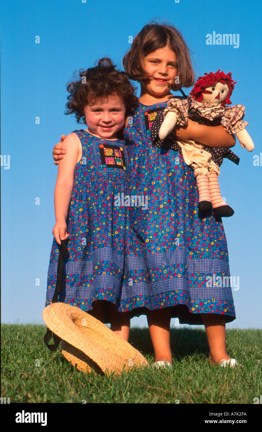 Sisters posing for camera Stock Photo - Alamy
