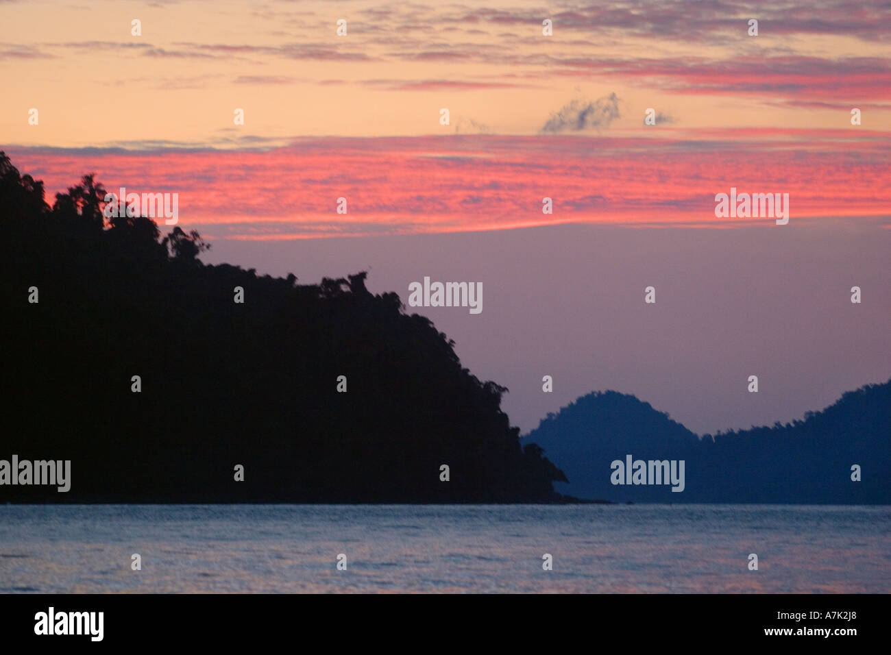 Sunset over the North Andaman Sea silhouettes hills dropping into the ...