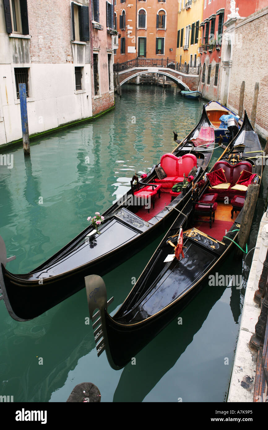 Iconic image of Venice two black gondola boats moored together on a ...