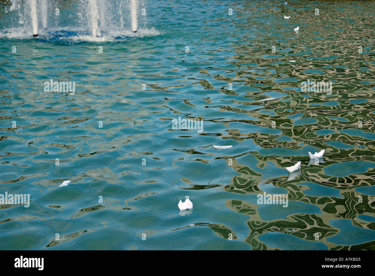 A origami boat folded from paper floating in the water fountain Stock ...