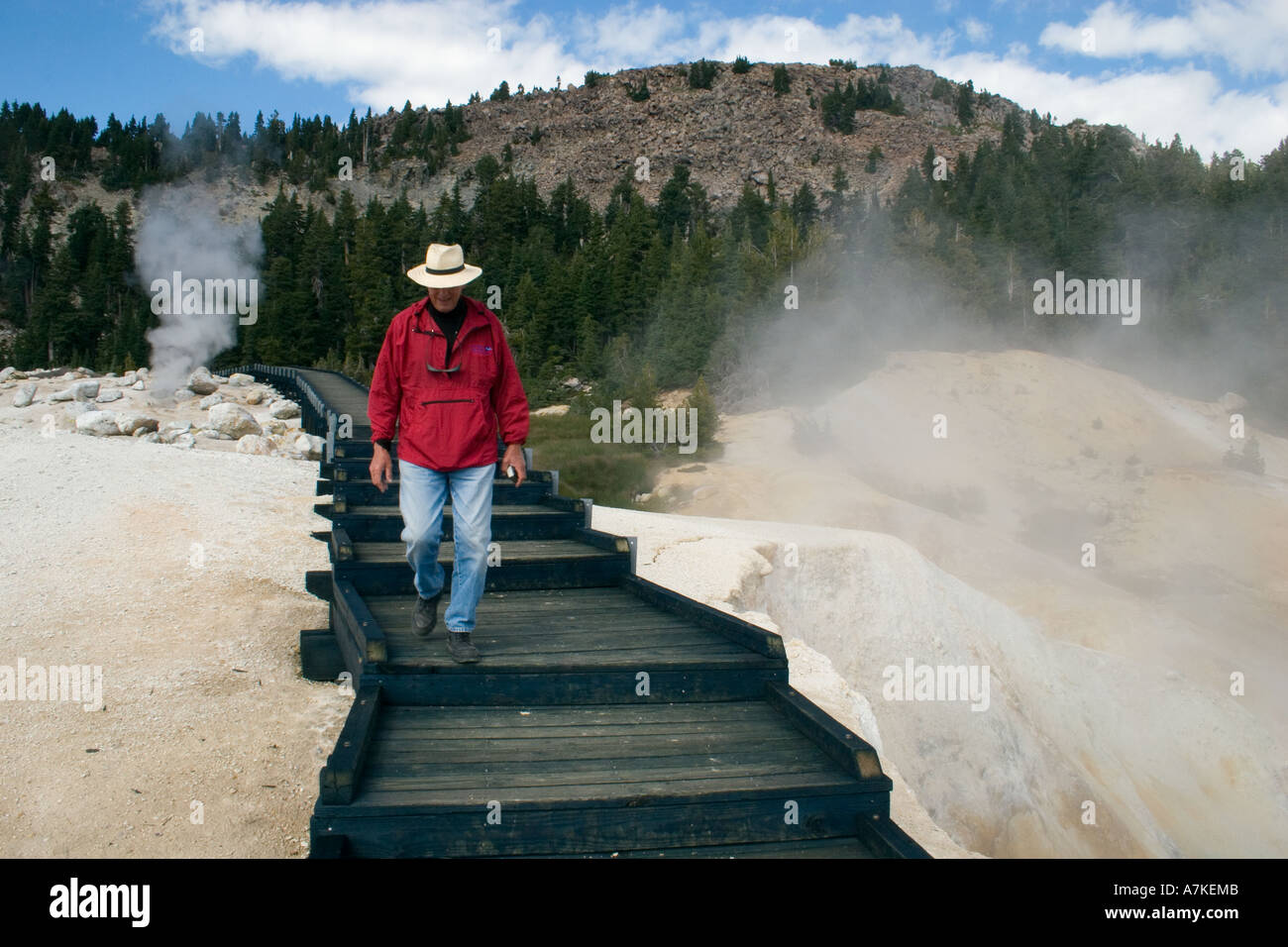 Steam engulfs visitors on a wooden pathway at the hot sulphur springs ...