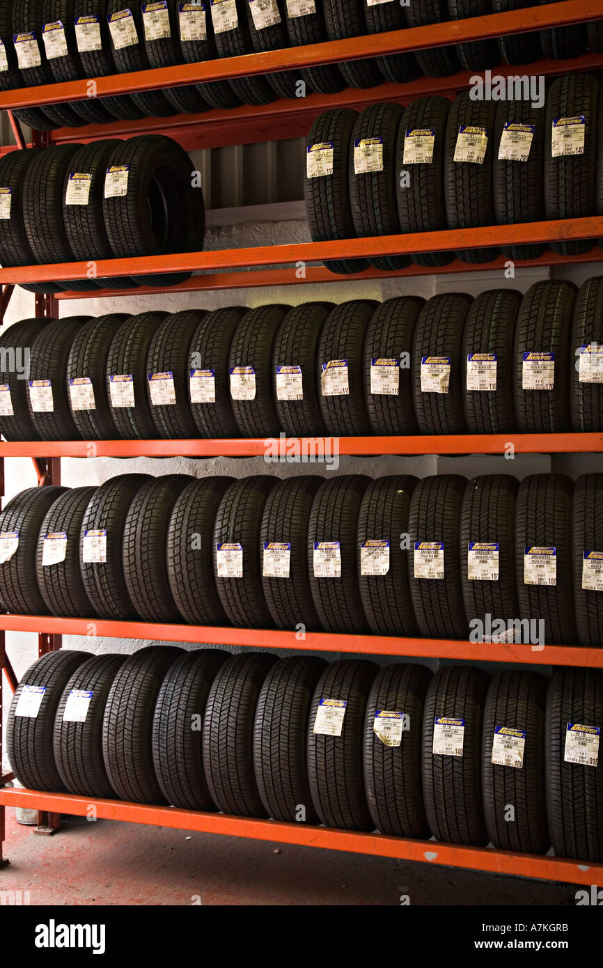 New car tyres on racks in fitting garage Wales UK Stock Photo - Alamy