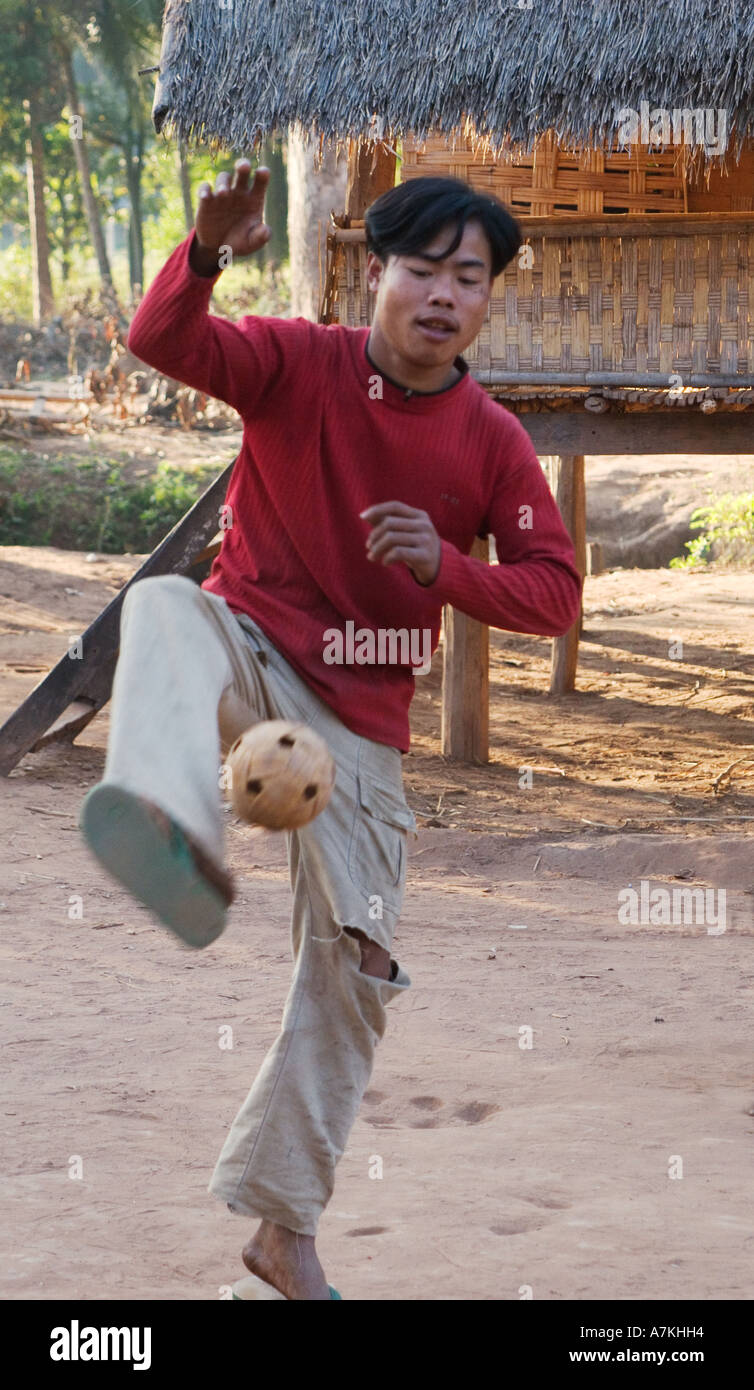 Young Laotian man plays kick ball in LUANG PROBANG LAOS Stock Photo - Alamy