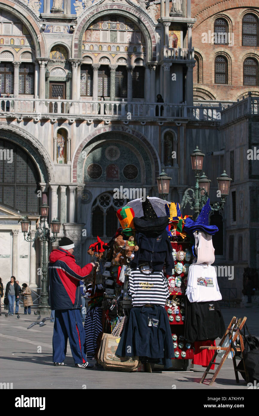 Italian street vendor sets up his central Venice tourist souvenir stall in St. Marks Square ...
