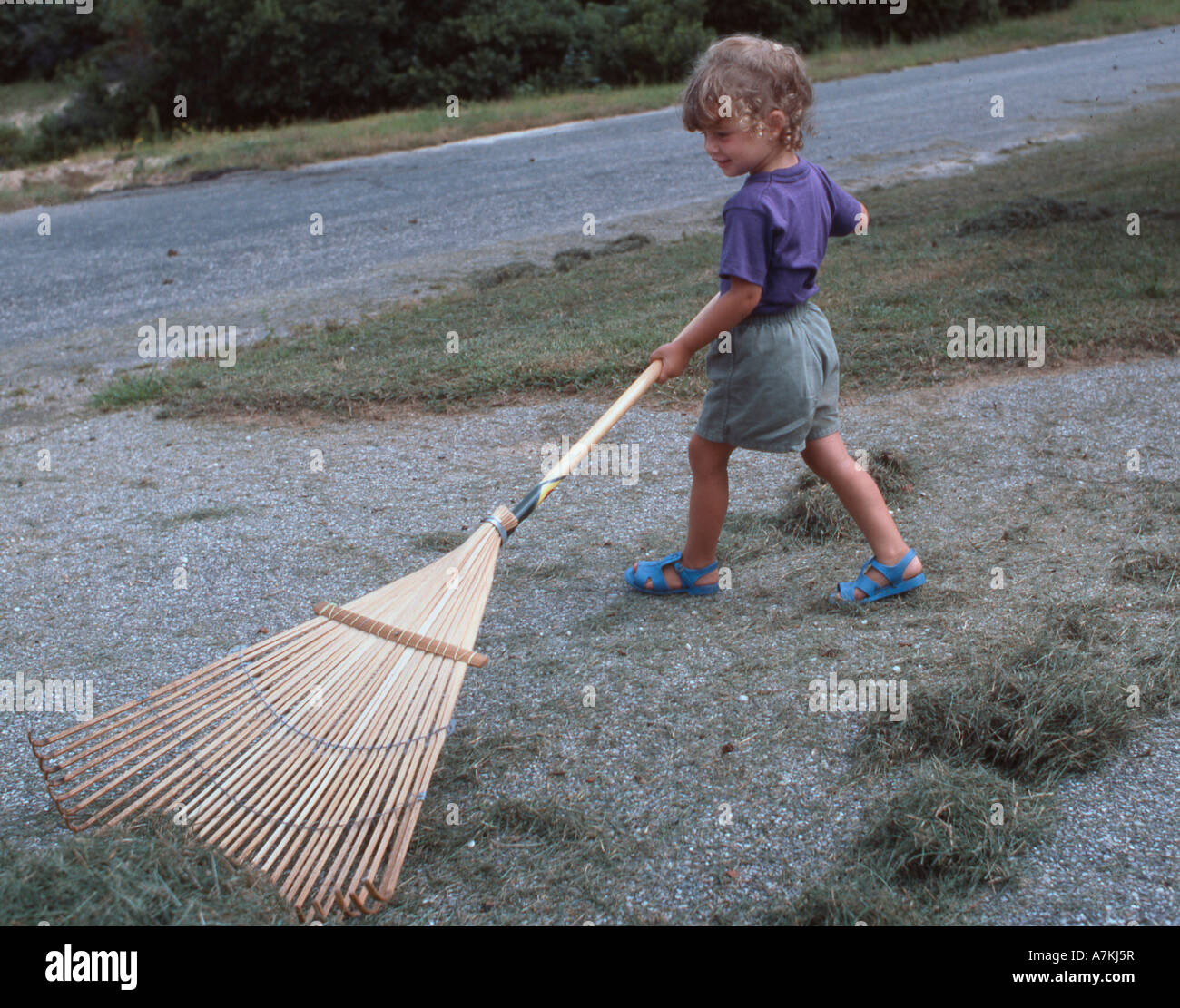 Child holding rake hi-res stock photography and images - Alamy