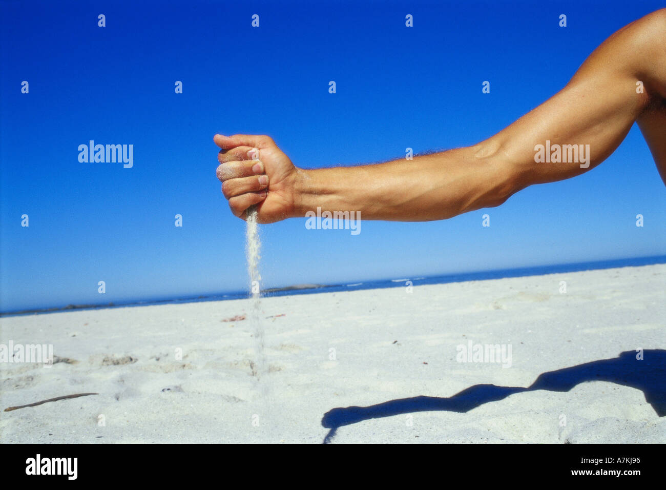 Person pouring sand on the beach Stock Photo - Alamy