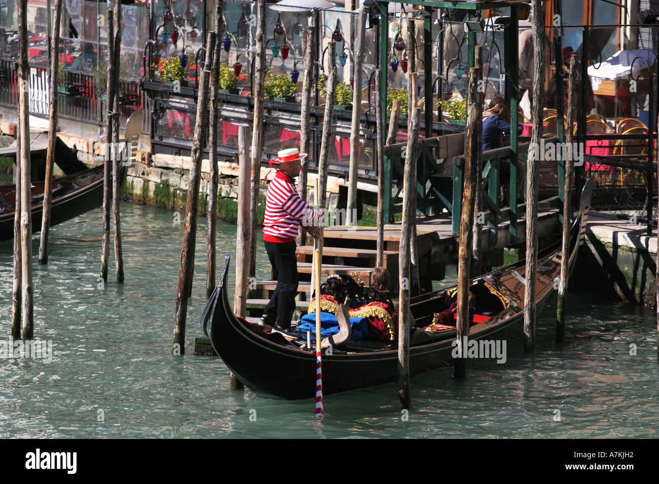 Typical Venetian gondola man in iconic colourful uniform waits for ...