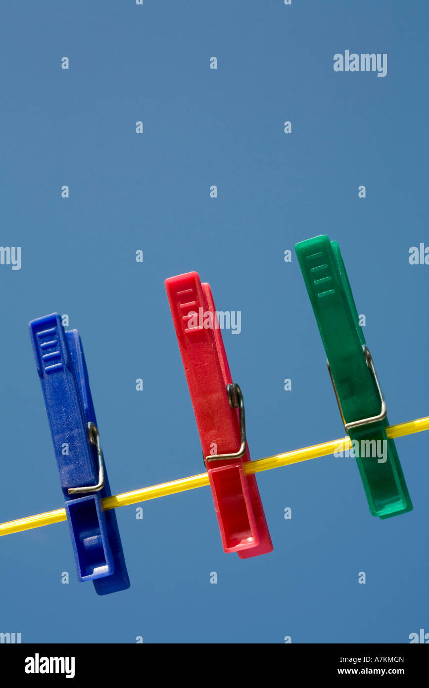 Clothes pins on a washing line against a blue sky Stock Photo - Alamy