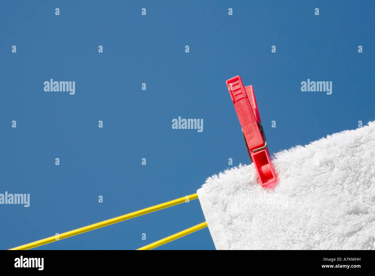 Clothes peg on a white towel and washing line against a blue sky Stock ...