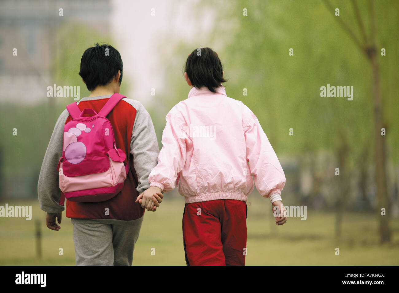 two chinese pupils going home hand in hand Stock Photo - Alamy