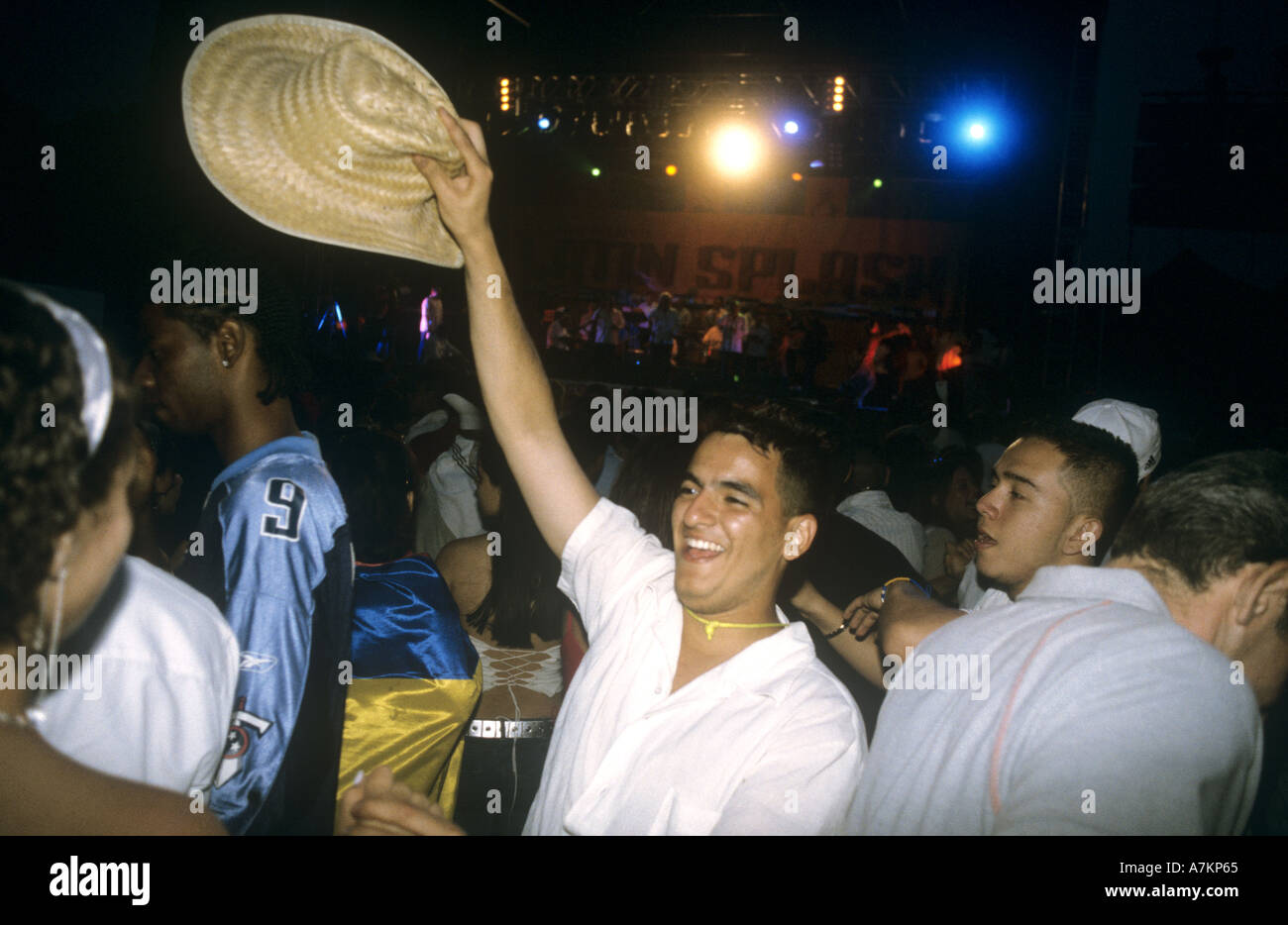 A latino man raises his hat at a salsa concert, Latin Splash 2003 on ...