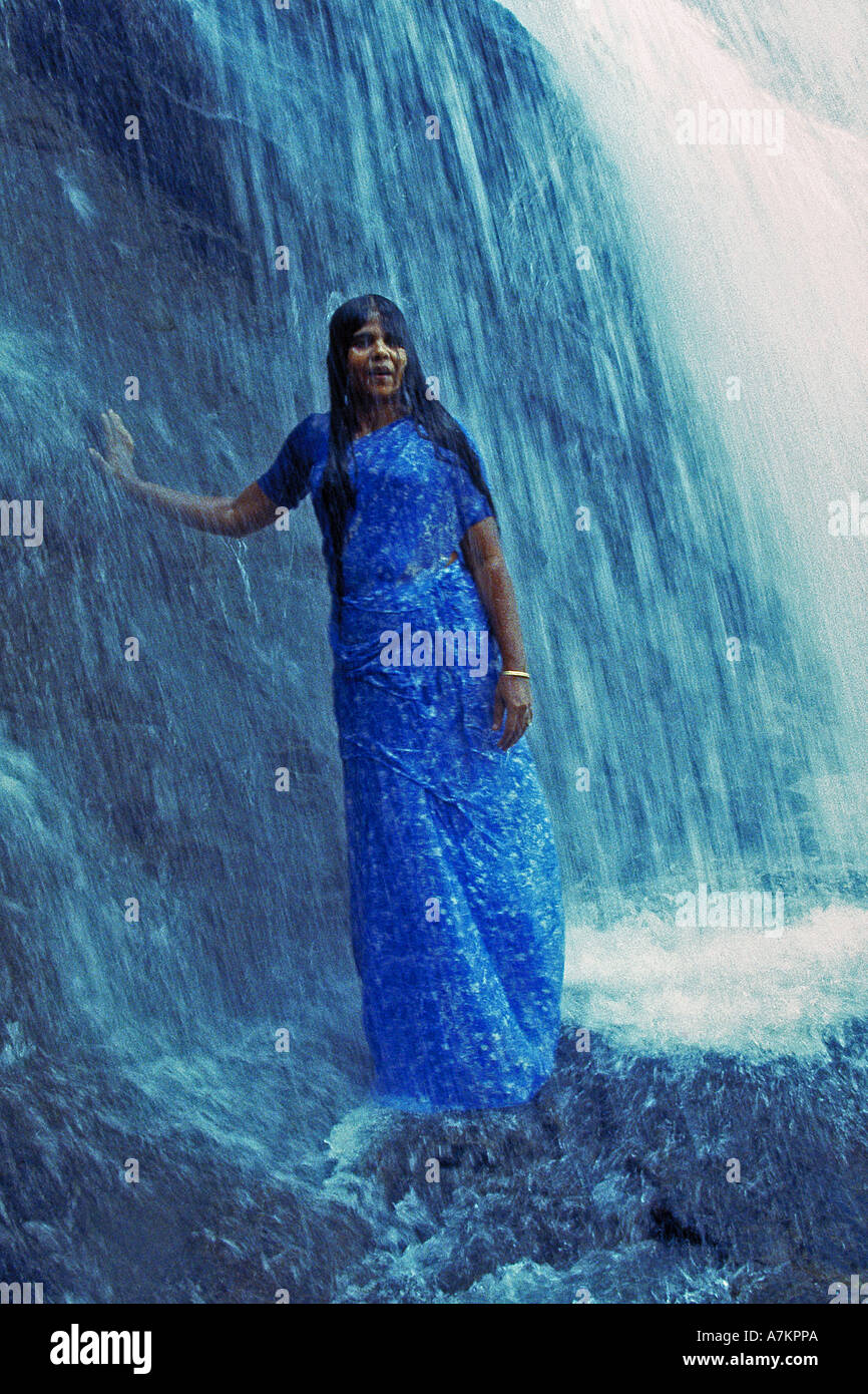 Young girl washing in a waterfall South India Stock Photo - Alamy