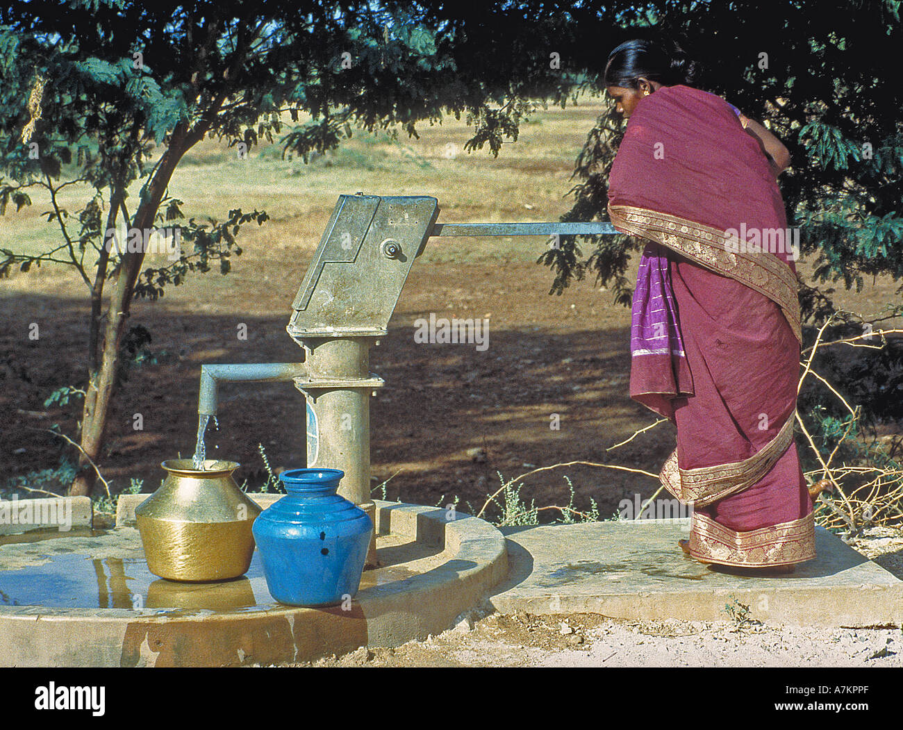 Woman pumping water South India Stock Photo - Alamy
