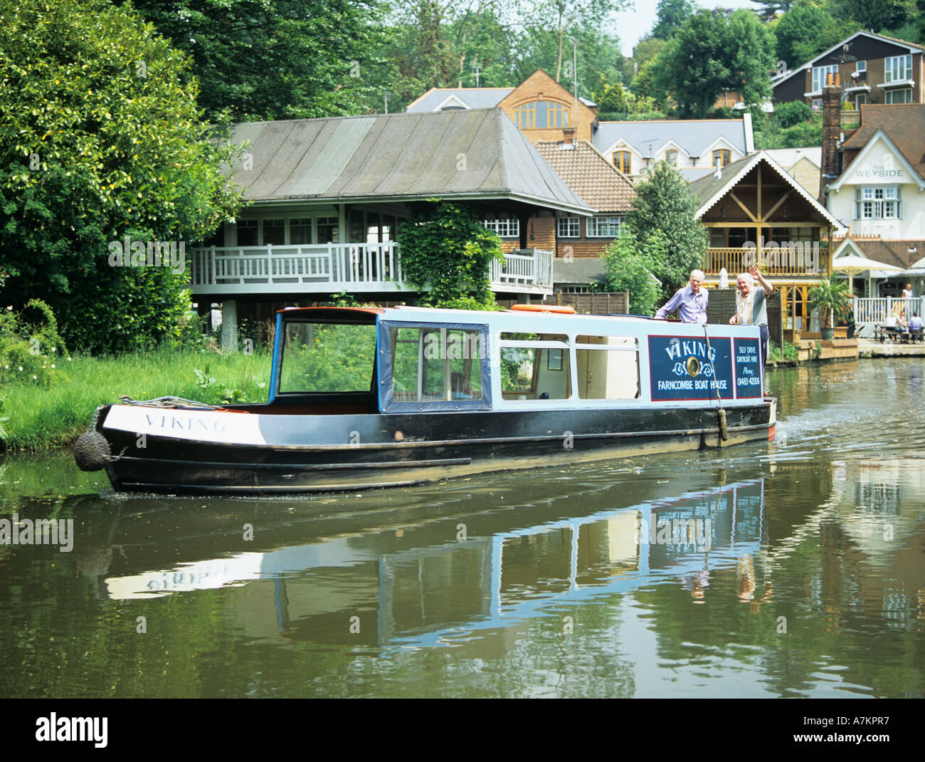 GUILDFORD SURREY UK May Light blue and black canal boat passing the ...