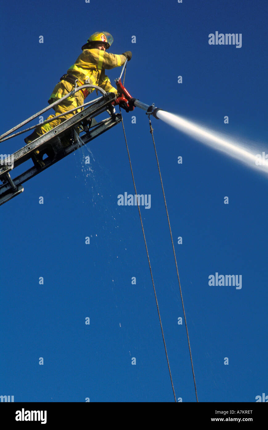 Detroit Michigan A fire fighter sprays water on a fire from high atop a ...