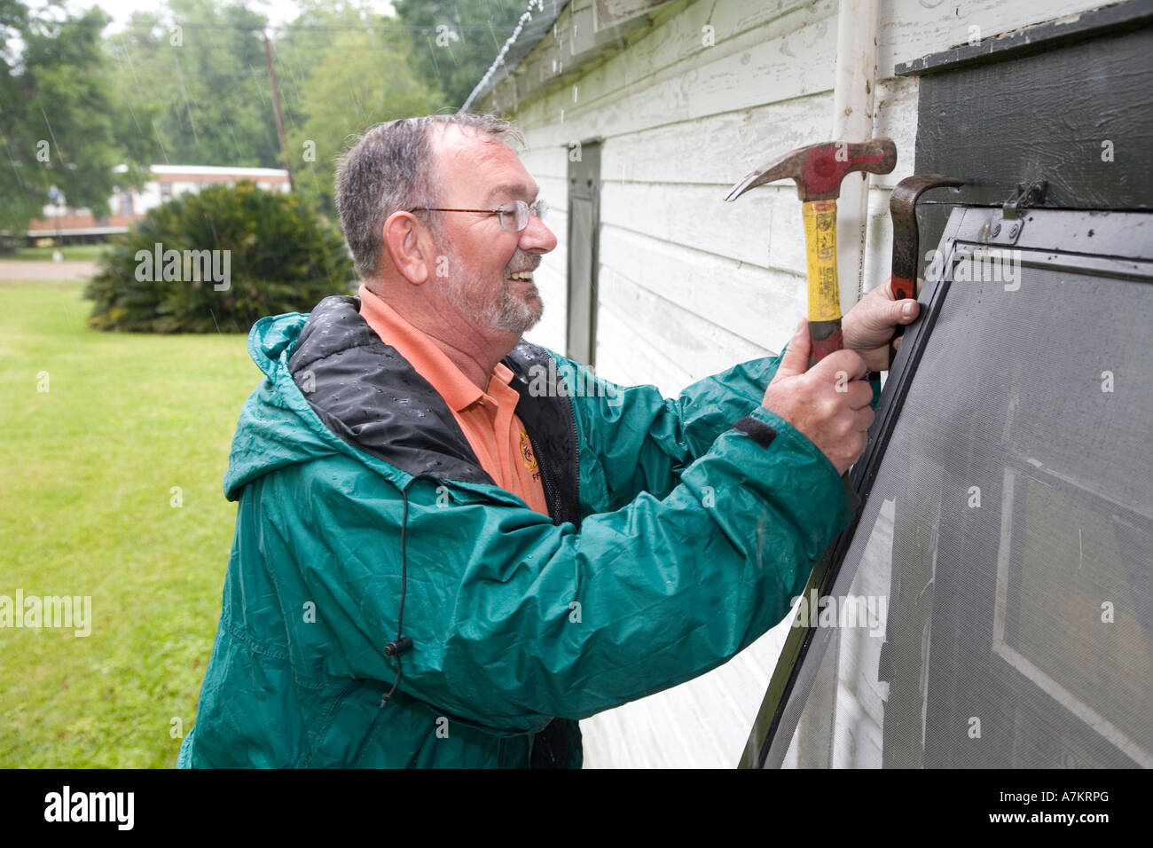 Volunteer Repairs Home for Low-Income Family Stock Photo - Alamy