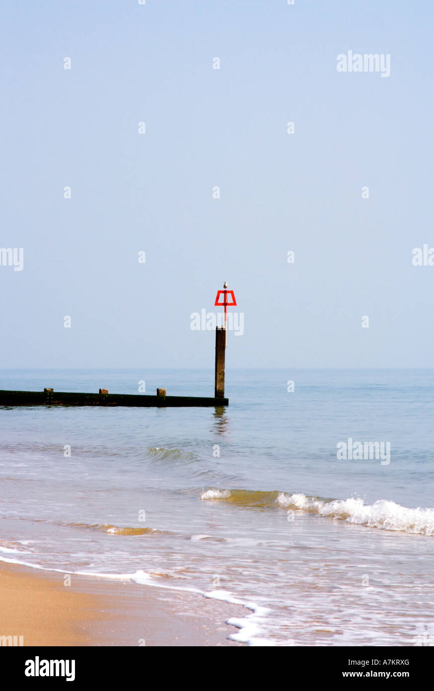 Groyne with red warning marker and seagull. Bournemouth beach. Dorset ...