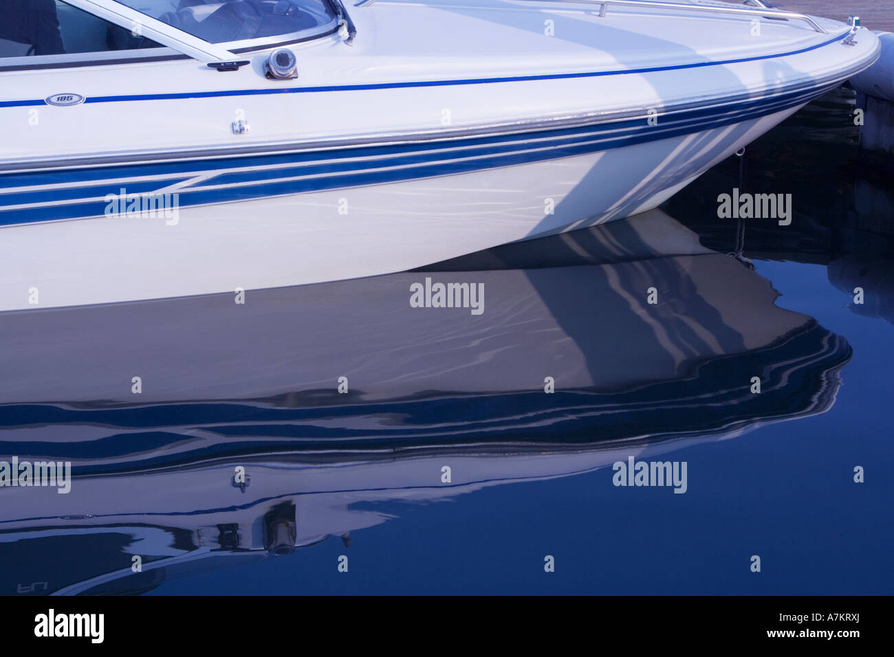 White speedboat reflected in blue water. UK Stock Photo - Alamy