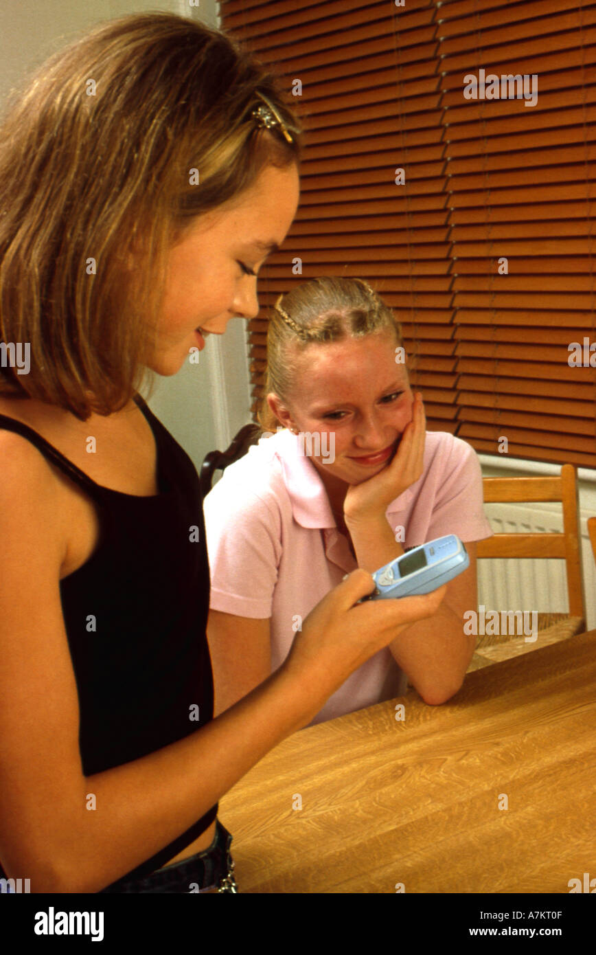Girls texting on mobile phones Stock Photo - Alamy