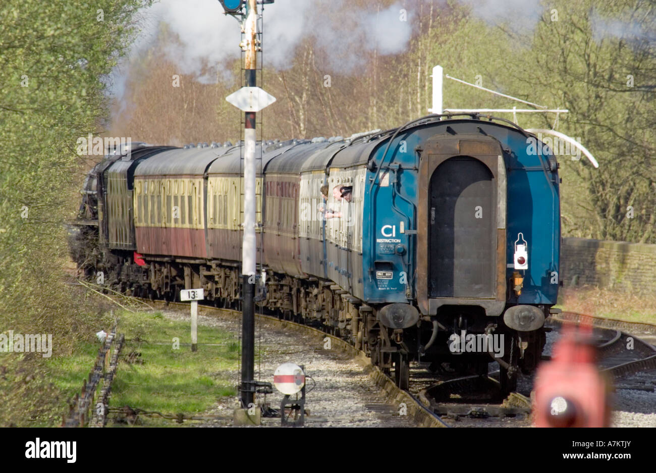 A steam hauled passenger train pulls away from Ramsbottom station Stock ...