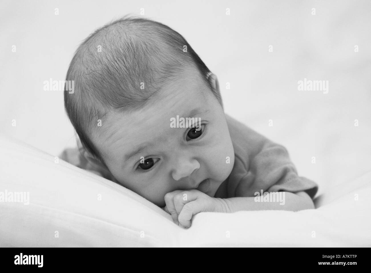 Adorable gorgeous newborn baby with inky black cute lovable big eyes ...