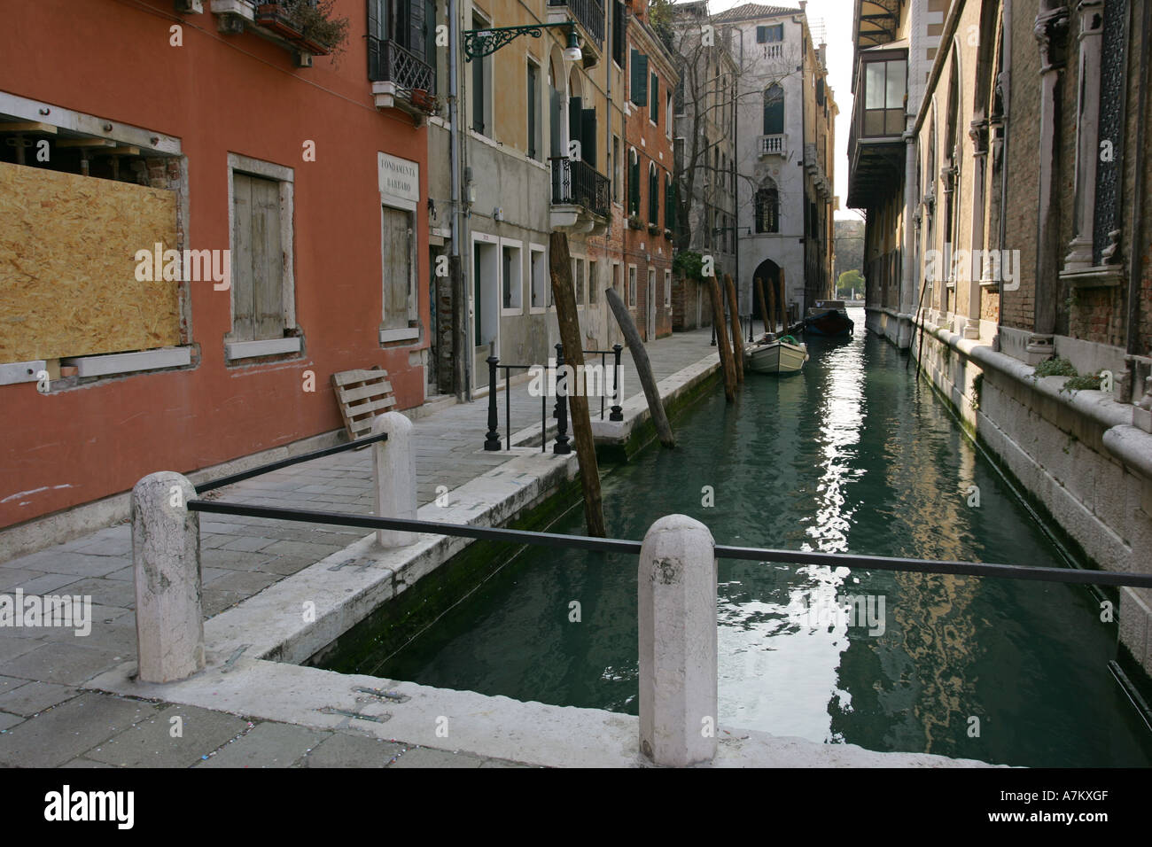 Small deserted narrow Venice backwater waterway leading to the Grand ...