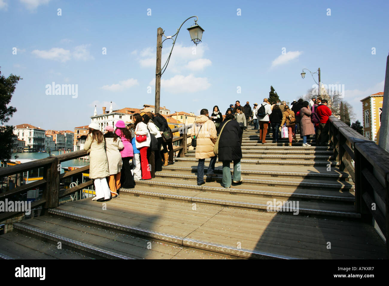 Tourists climb the ancient steps of the Accademia bridge Ponte dell ...