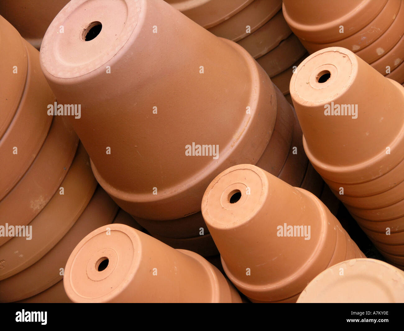 Terracotta round flower pots in stacks Stock Photo - Alamy