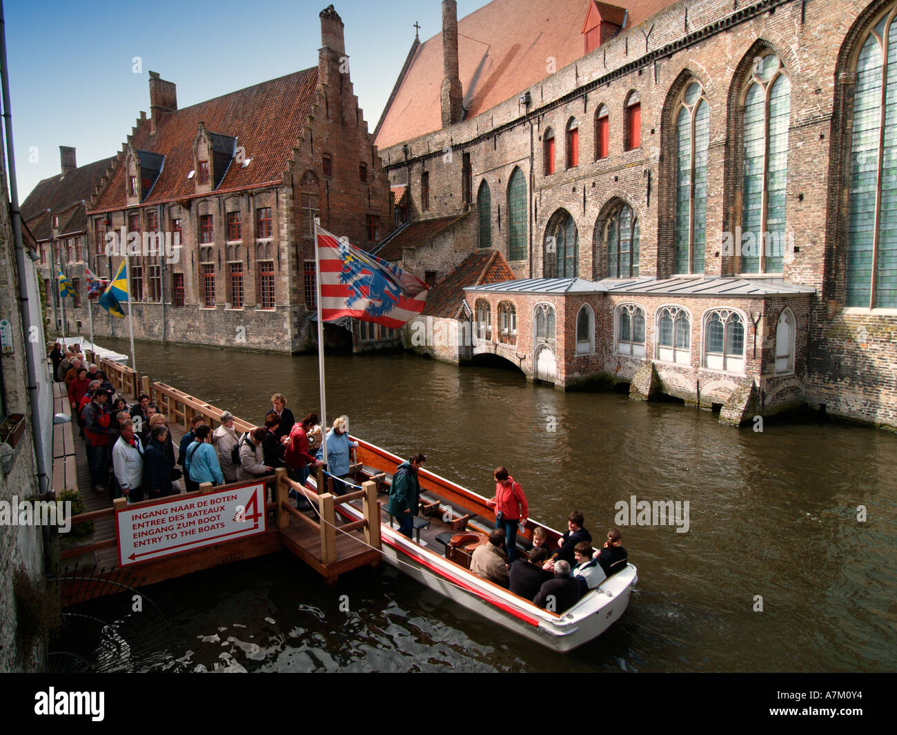 Many tourists entering boarding guided tour boat in the historic city ...