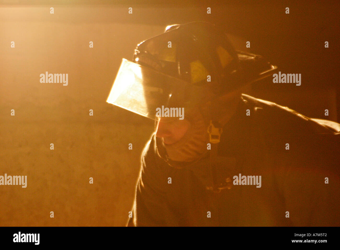 Fire fighter at a scene of a structure collapse during a wintry evening ...