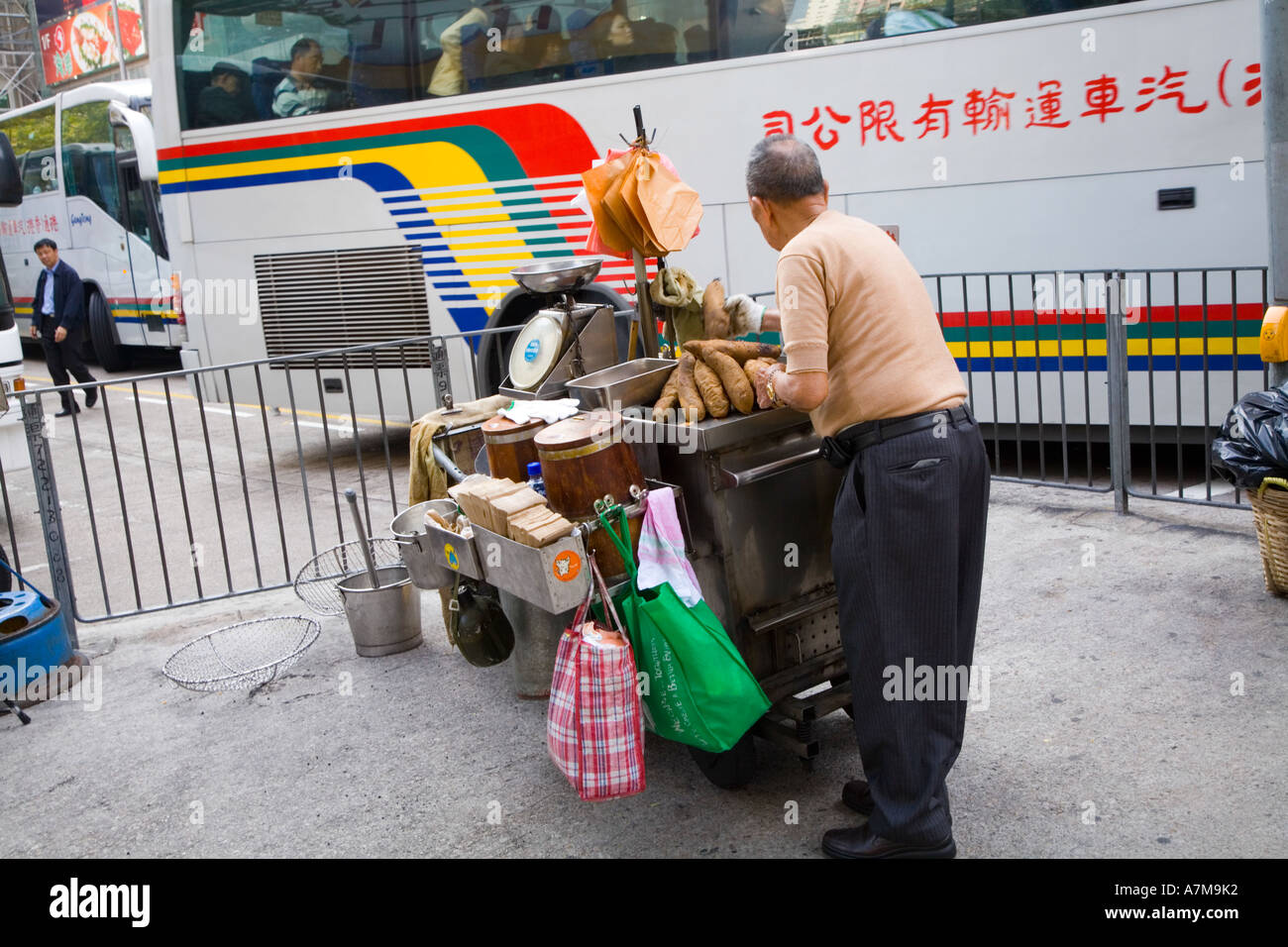 Man selling food at a street food stall in Kowloon Stock Photo - Alamy