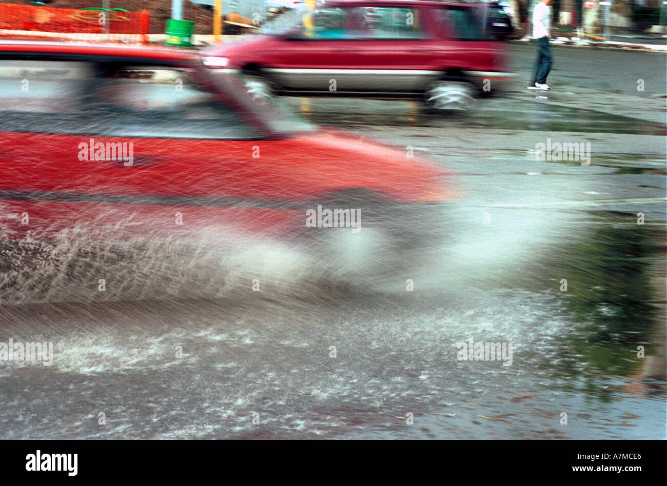Car speeding by in flooded street Stock Photo - Alamy
