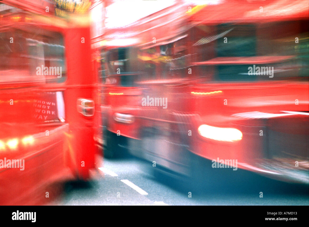 Red London buses speeding by Stock Photo - Alamy