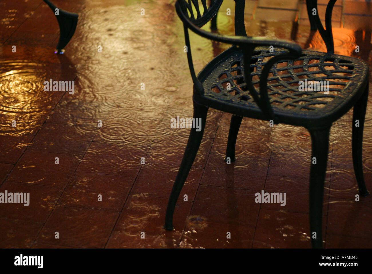 chair in rain reflecte light in puddles Stock Photo - Alamy