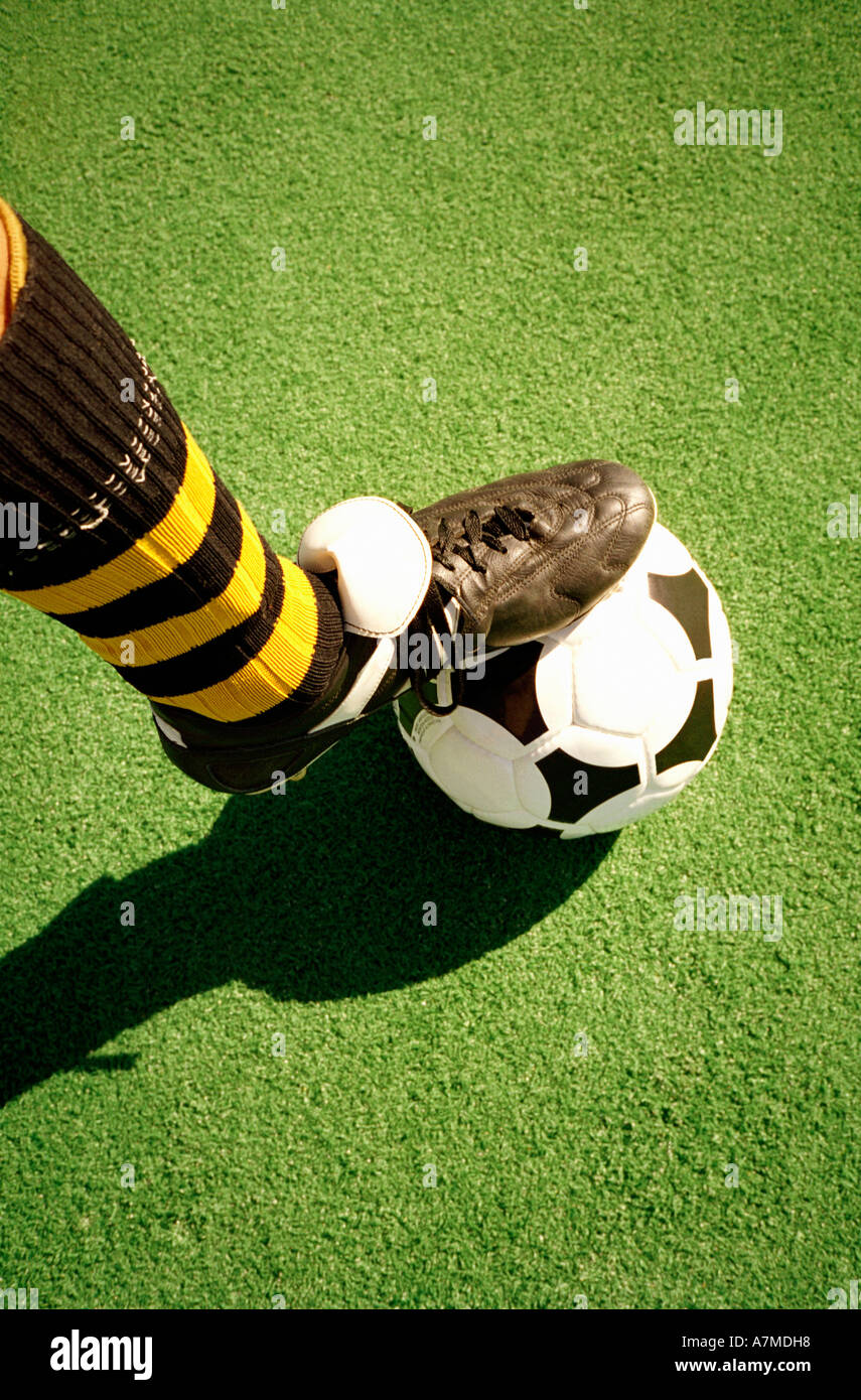 Soccer player balancing foot on top of ball Stock Photo - Alamy