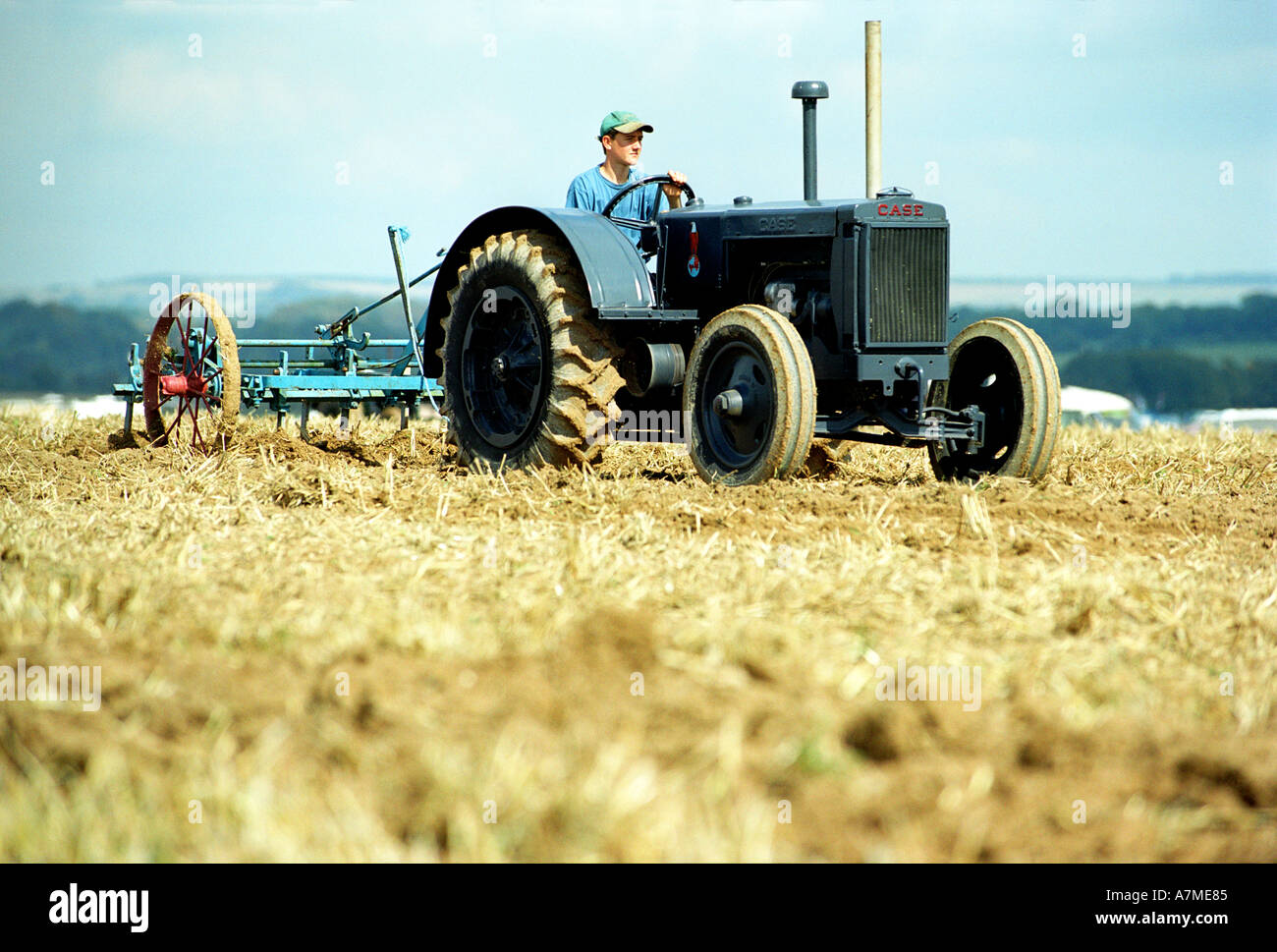 Tractor, An old fashioned vintage working tractor ploughing a field ...