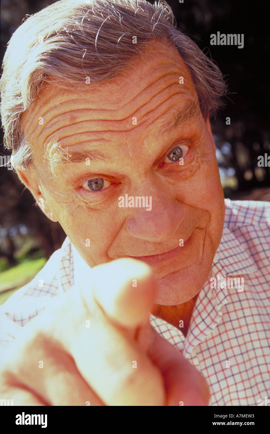 Smiling elderly man pointing hi-res stock photography and images - Alamy