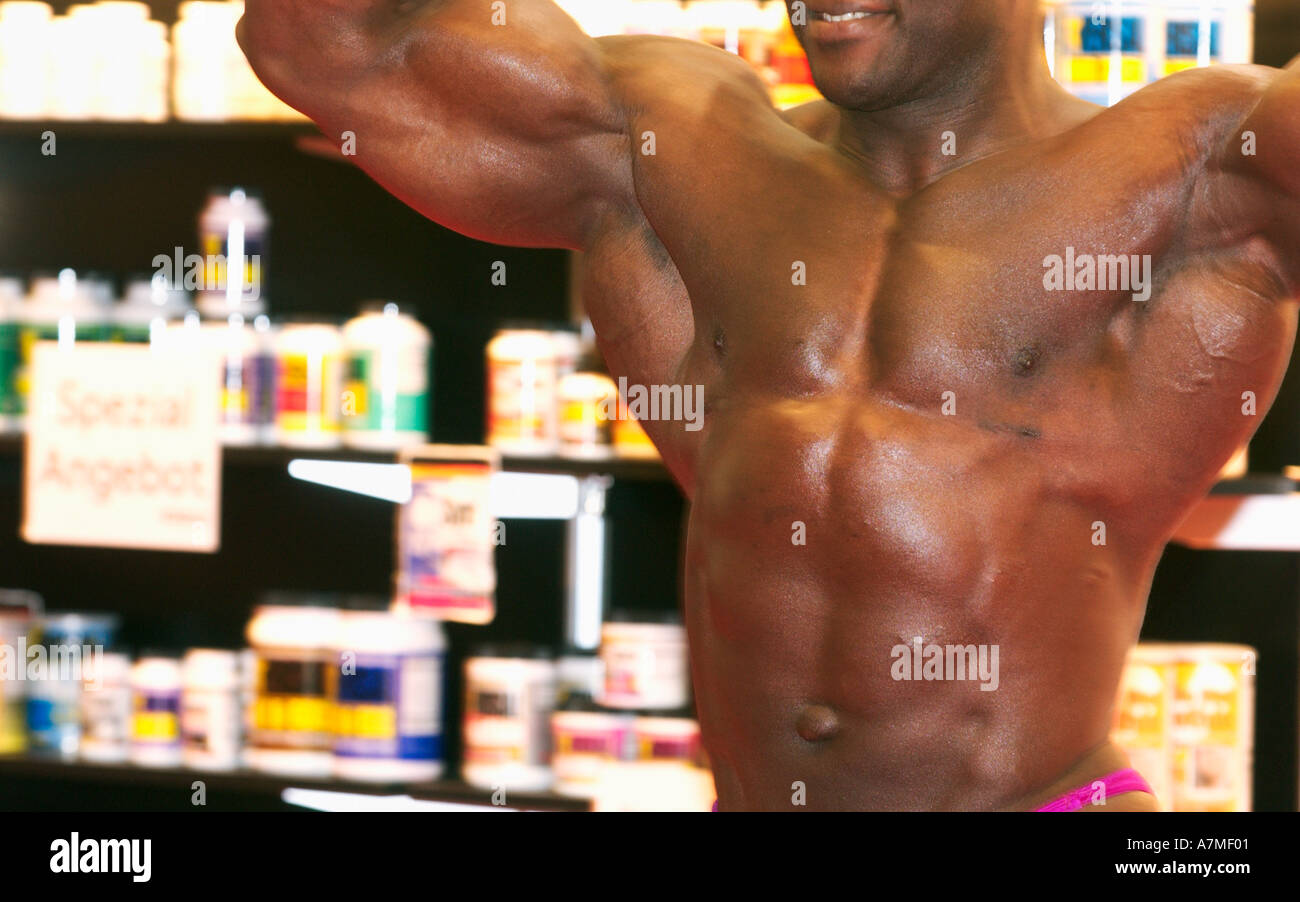 detail of a male bodybuilder in front of a nutrition shelf Stock Photo ...