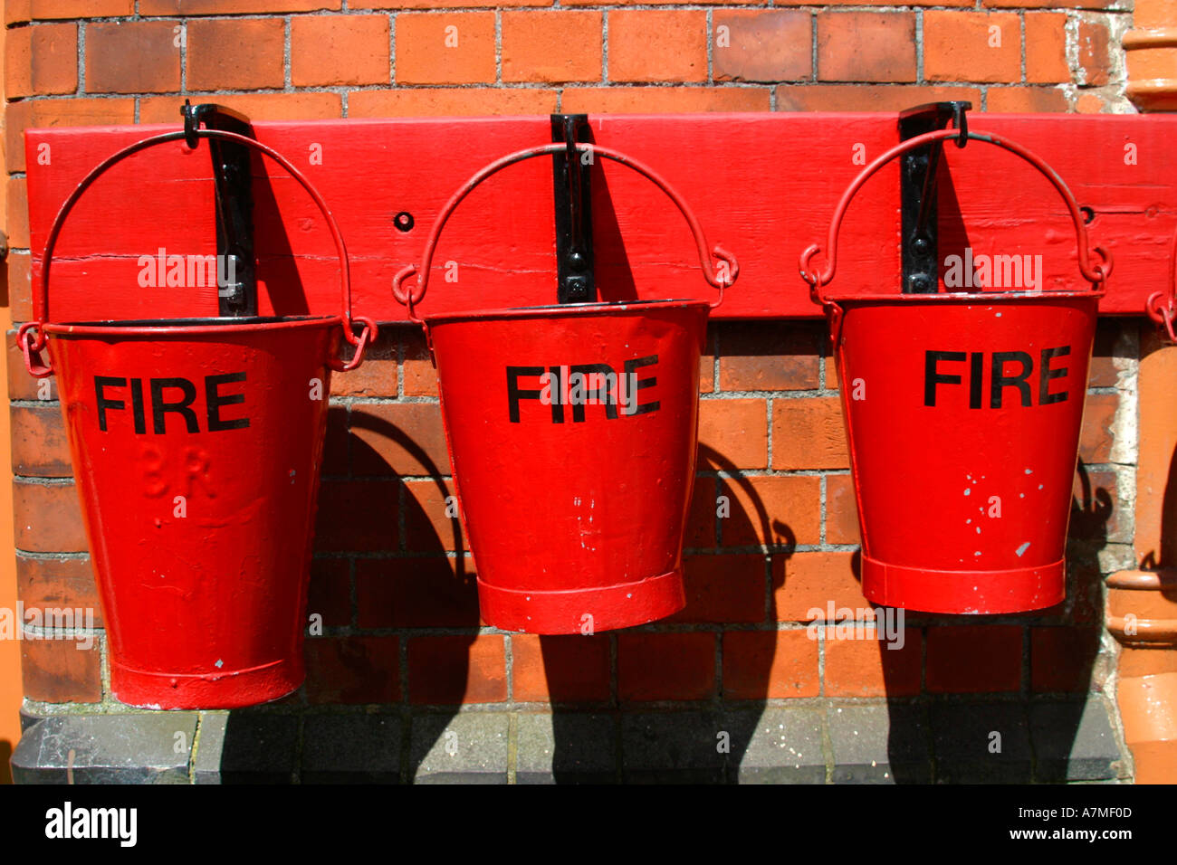 Red fire buckets filled with sand Stock Photo - Alamy