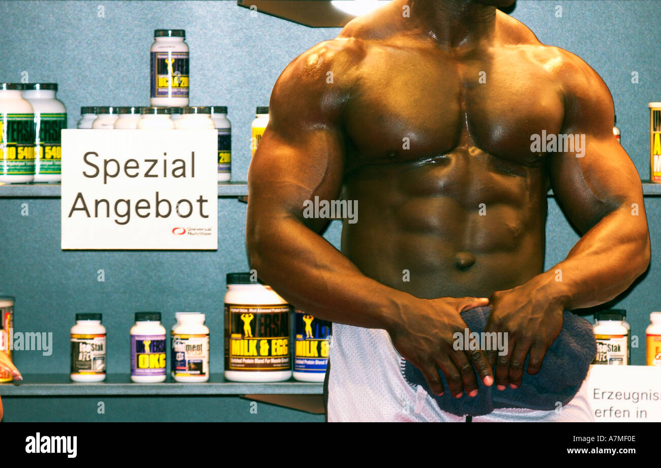 detail of a male bodybuilder in front of a nutrition shelf with special ...