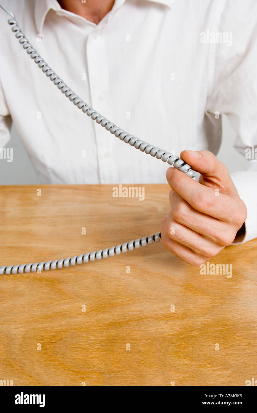 A man holding a telephone cord Stock Photo - Alamy