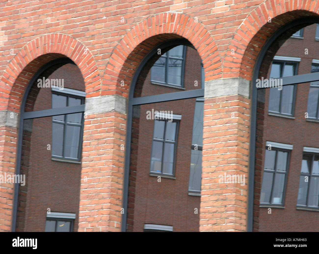 Brick arched windows and reflections in the glass in Amsterdam Stock ...