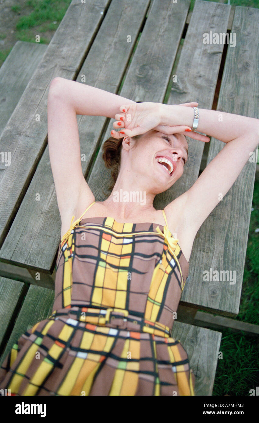 Woman lying on picnic table hi-res stock photography and images - Alamy