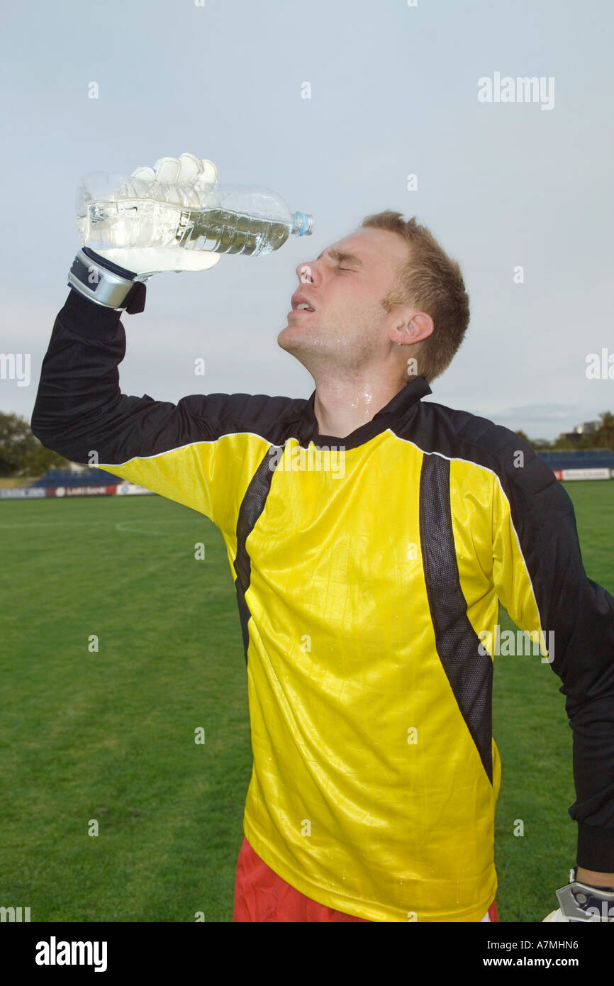 A goalie pouring water on his face Stock Photo - Alamy
