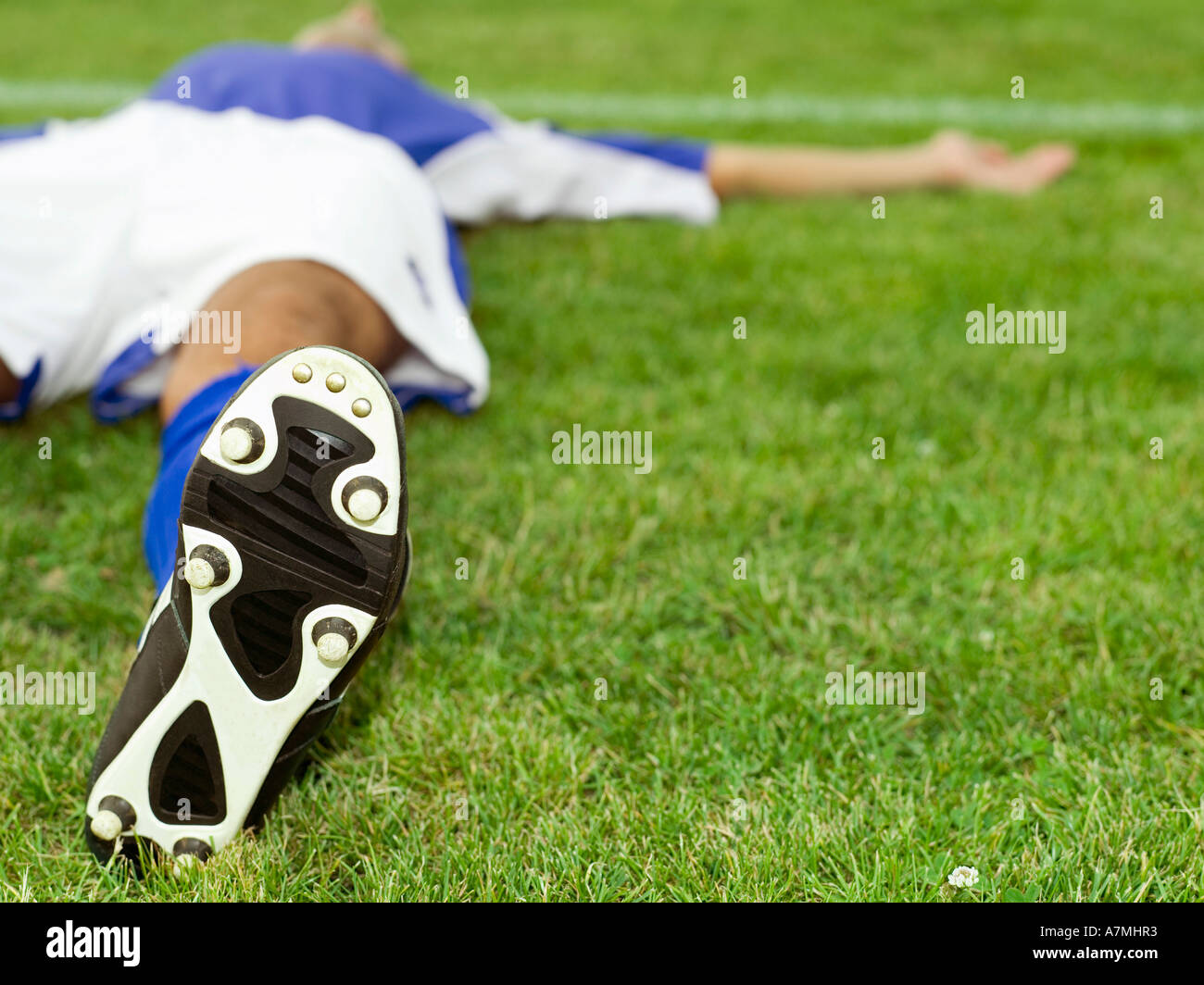 A soccer player lying down Stock Photo - Alamy