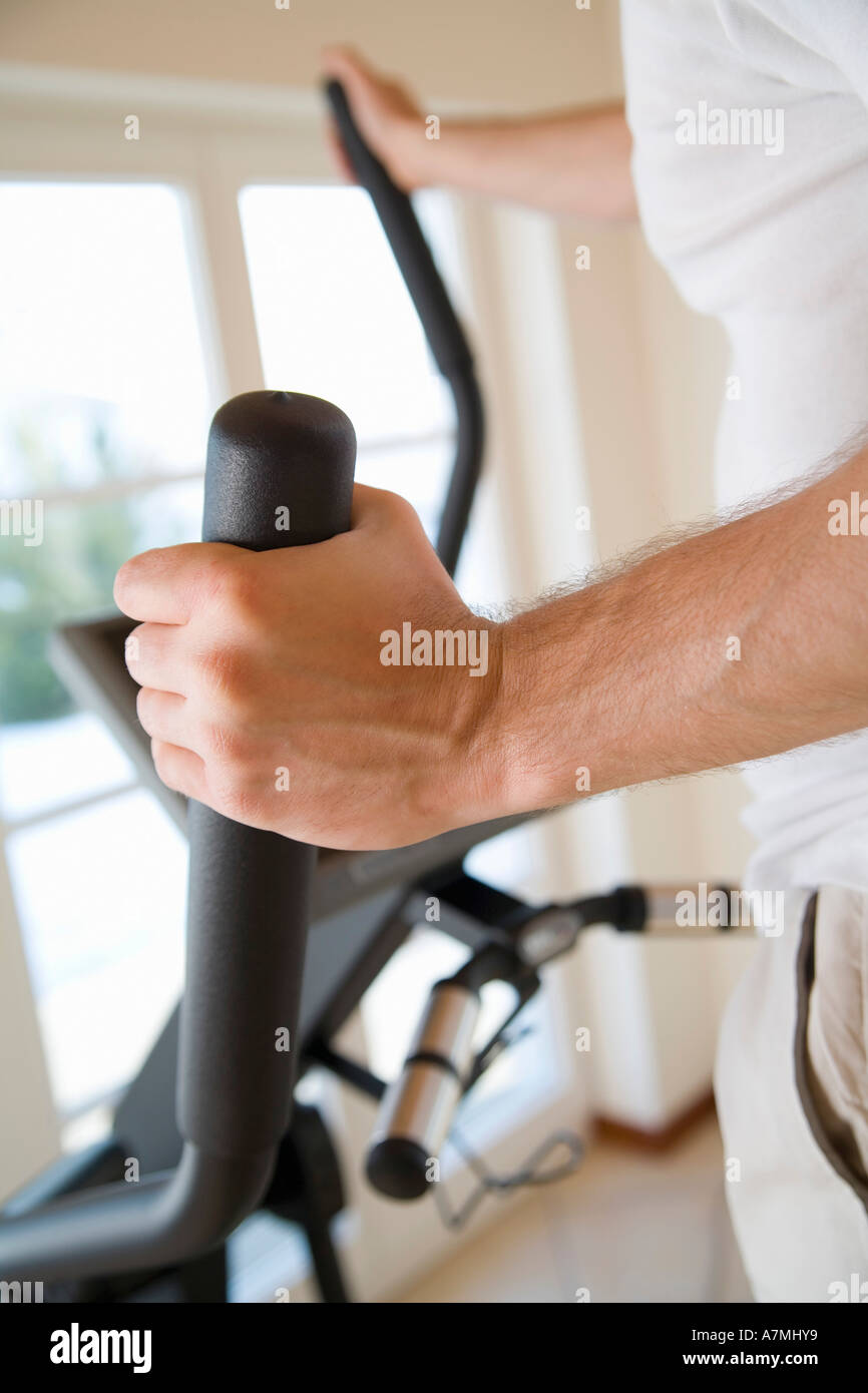 Man using exercise equipment Stock Photo - Alamy