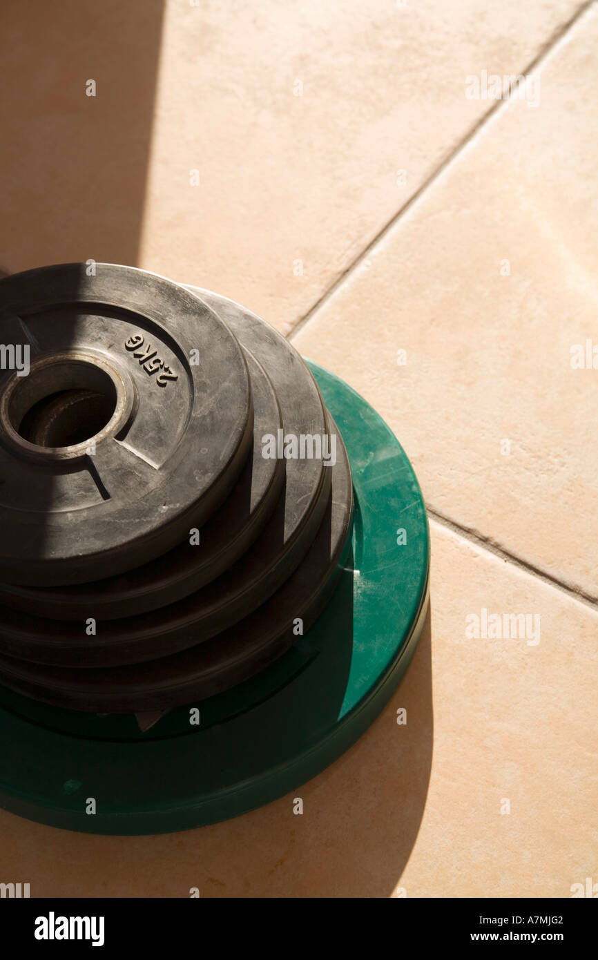 Stack of weights on floor Stock Photo - Alamy