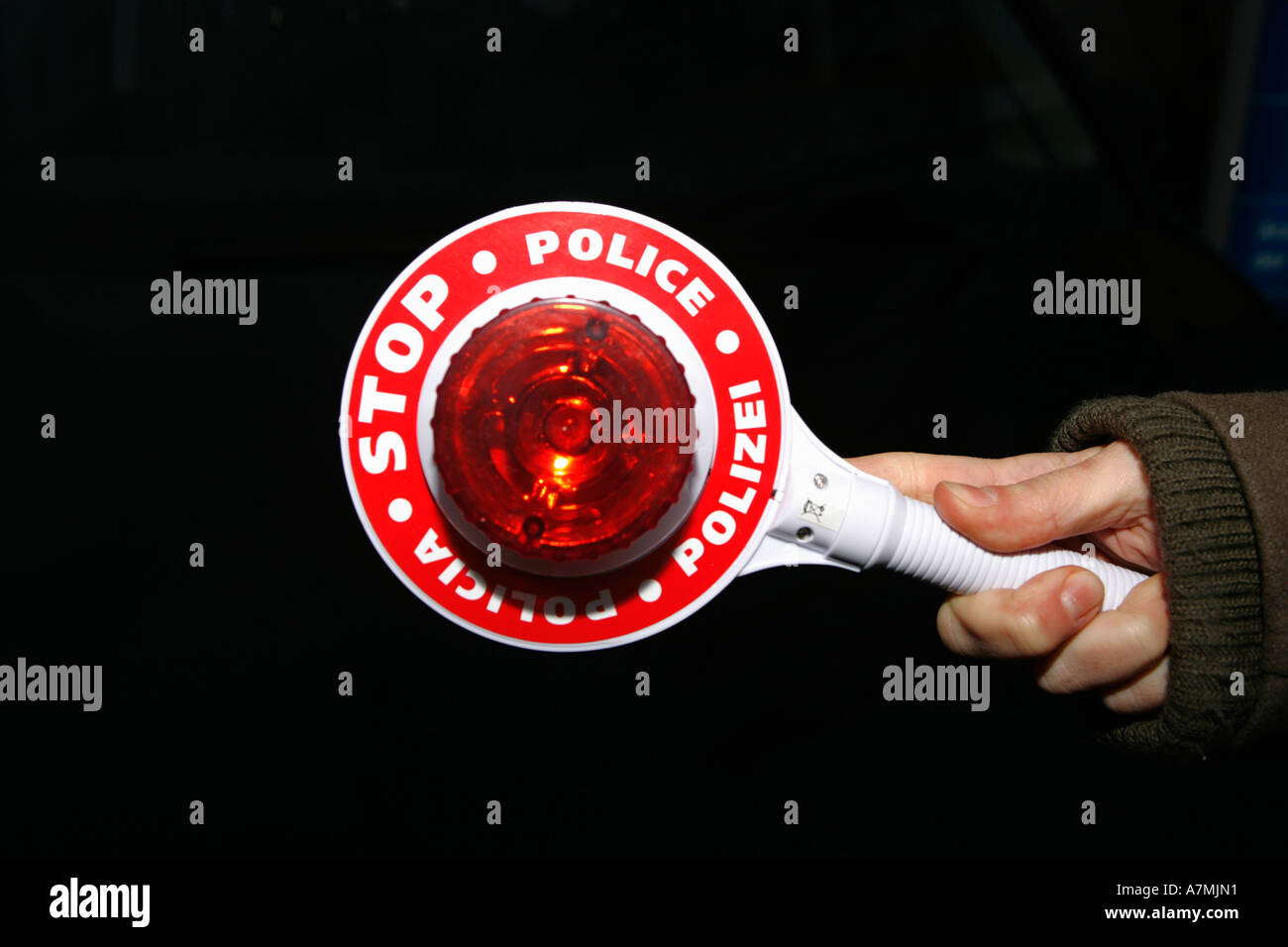 Police officer holding stop sign Stock Photo - Alamy